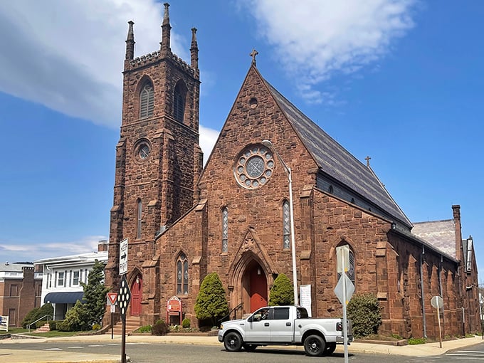 That gorgeous stonework church tower rises like a beacon over streets where your grocery budget breathes easier.