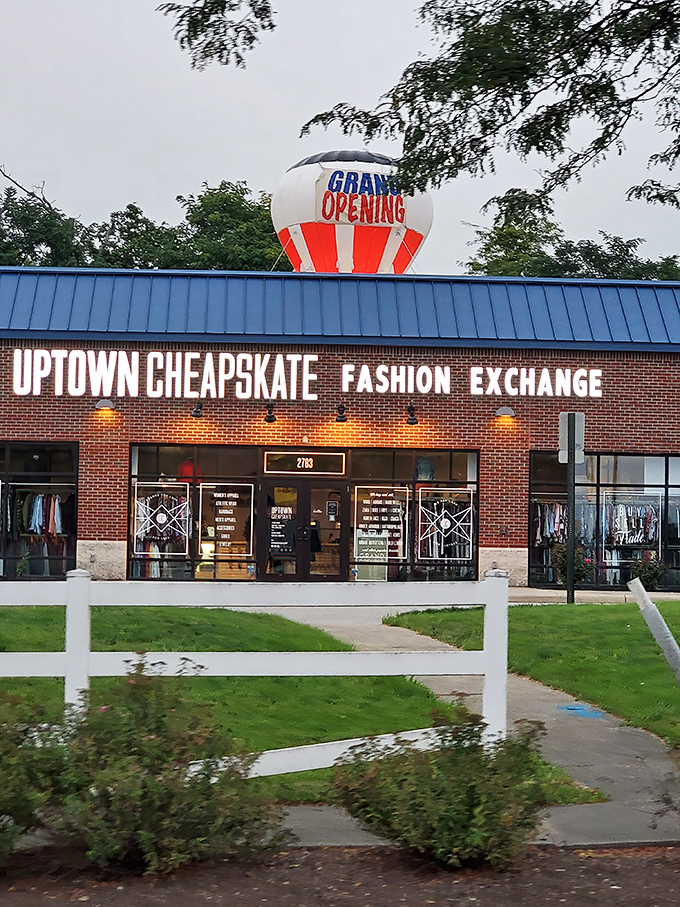 Uptown Cheapskate's brick storefront with its "Grand Opening" balloon promises a boutique experience at thrift store prices.