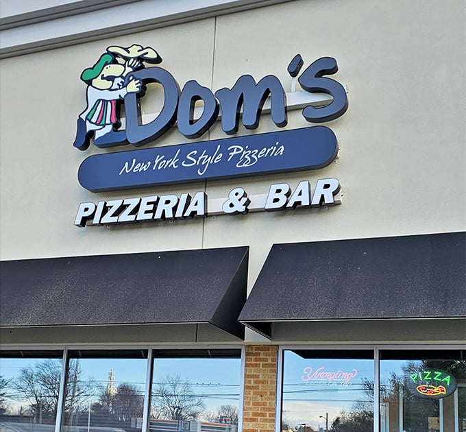 Dom's cheerful chef logo waves hello, beckoning pizza lovers into this cozy neighborhood gem.