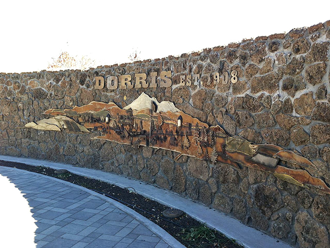 The town's welcome sign proudly displays community spirit, like a friendly handshake from 900 neighbors.
