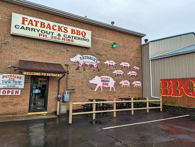 Pink pigs march across the brick like a delicious parade announcing serious barbecue business inside.
