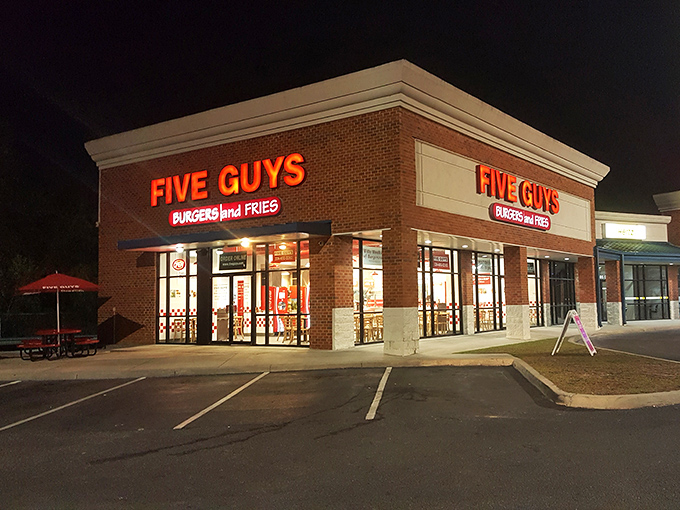 When night falls, this Five Guys glows like a beacon for hot dog lovers seeking customizable delights after dark.
