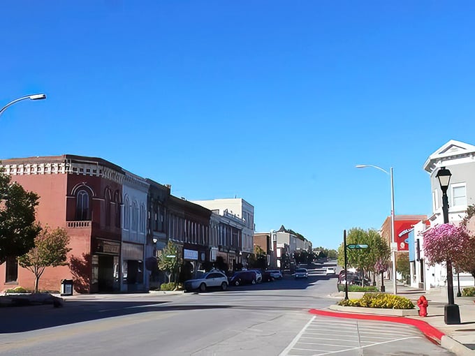 Tree-lined streets frame historic storefronts where generations of families have shopped, laughed, and built memories.