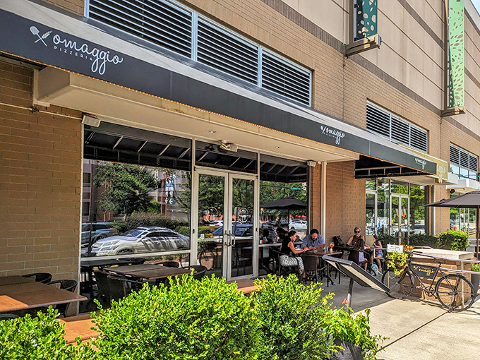 Urban oasis for pizza lovers. Omaggio's outdoor seating surrounded by greenery offers a civilized escape from Charlotte's concrete jungle.