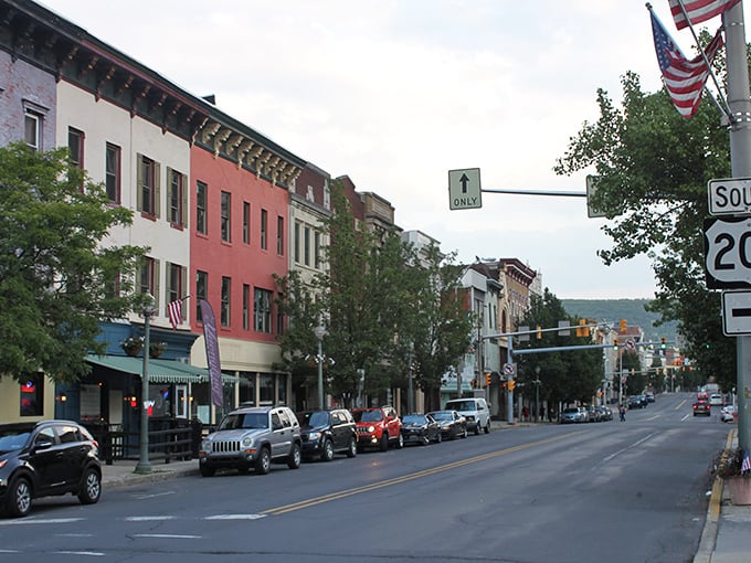 The American flag waves proudly over Pottsville's colorful row of affordable apartments. Like finding vintage treasures at yesterday's prices—charming spaces that won't send your bank account into therapy!