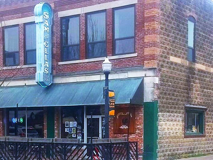 A simple table outside a legendary pizza joint. Sam & Ella's proves great pizza doesn't need fancy frills—just perfect ingredients and hometown charm.