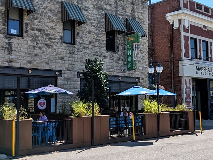 Blue umbrellas create the perfect outdoor breakfast spot where Kansas sunshine meets perfectly prepared morning meals.