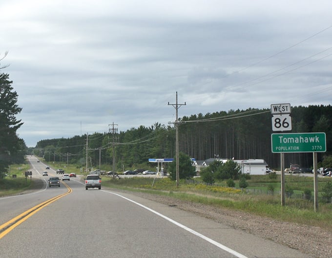 Tomahawk welcomes road-weary travelers with a classic green highway sign and the promise of northwoods peace.