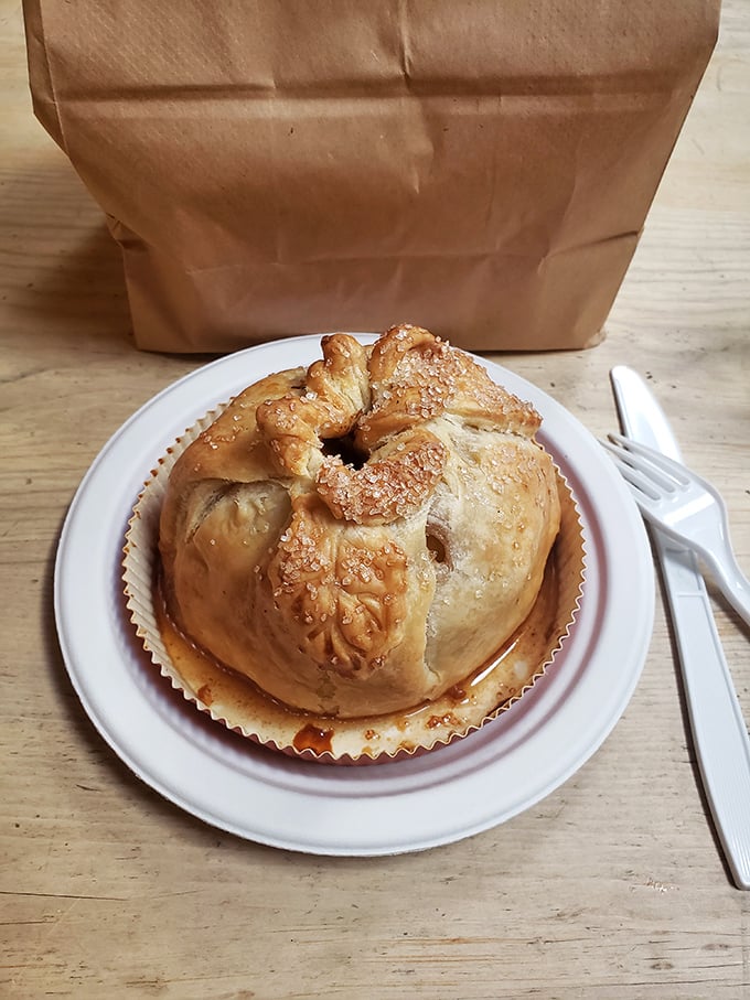 Behold the apple dumpling in its golden glory – an entire apple wrapped in pastry like it's wearing the world's most delicious winter coat.