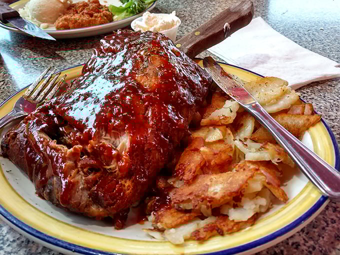 These BBQ ribs aren't just falling off the bone—they're practically jumping onto your fork, leaving a trail of sweet-tangy sauce that's worth the extra napkins.