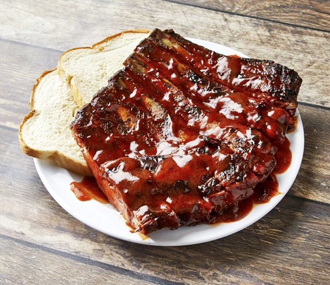 These ribs aren't just falling off the bone – they're practically volunteering to jump onto your plate with a perfect lacquer of sauce.