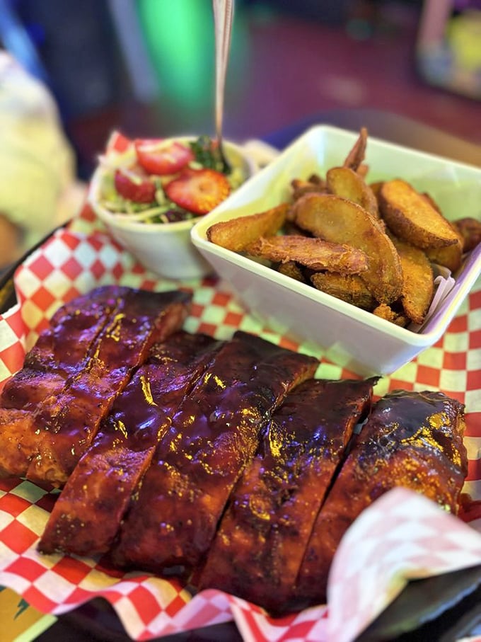Glistening baby back ribs with that perfect bark, served alongside golden potato wedges. This isn't just dinner—it's edible artwork with a smoky soul.