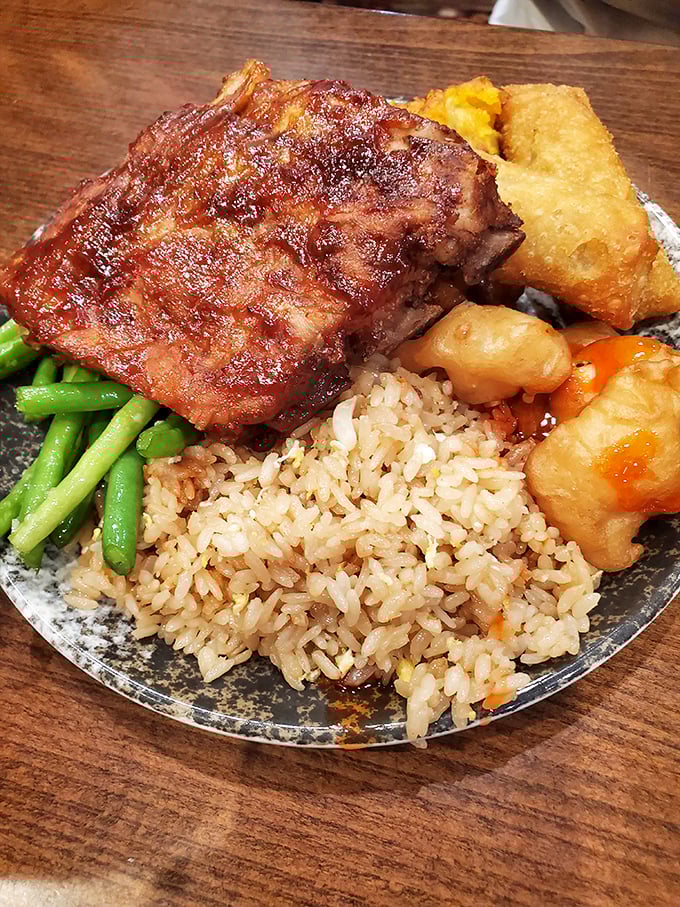 Fall-off-the-bone BBQ ribs share the spotlight with perfectly cooked rice and vibrant vegetables—a plate that bridges cultures with the universal language of "yum."