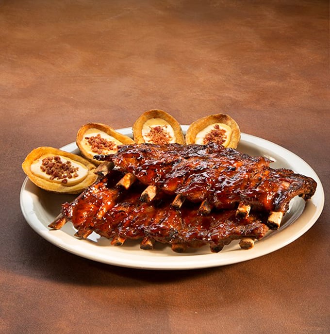 Behold, barbecue perfection on a plate. These ribs don't just fall off the bone—they practically leap into your mouth with glossy, caramelized urgency.