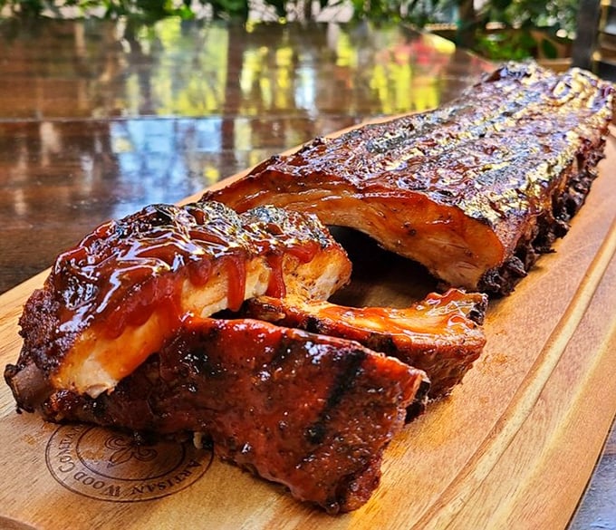 These ribs aren't just falling off the bone – they're practically jumping into your mouth with that glistening, caramelized bark that dreams are made of.