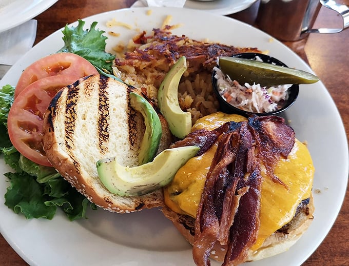 This isn't just a burger—it's architecture. Layers of bacon, cheese, and avocado create a savory skyscraper that demands both hands and napkins.