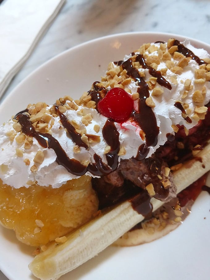 Behold the legendary banana split—a masterpiece of ice cream architecture where hot fudge meets cold cream in a symphony of sweet indulgence.