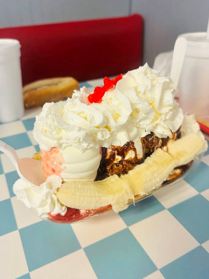 The banana split that launched a thousand road trips. Three scoops nestled between fresh banana, crowned with whipped cream and cherries—worth every mile of the journey.