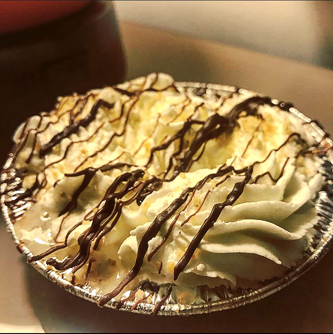 Banoffee pie with chocolate drizzle—proof that banana, toffee, and cream can achieve what most international peace treaties cannot.