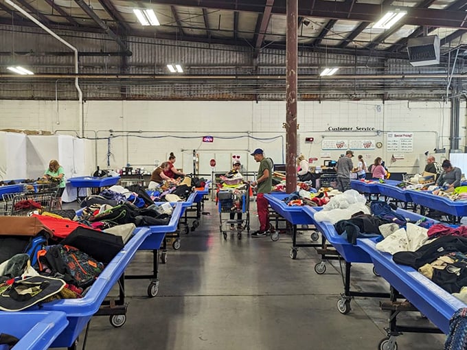 Behind the scenes where the magic happens – volunteers transform mountains of donations into organized opportunity zones.