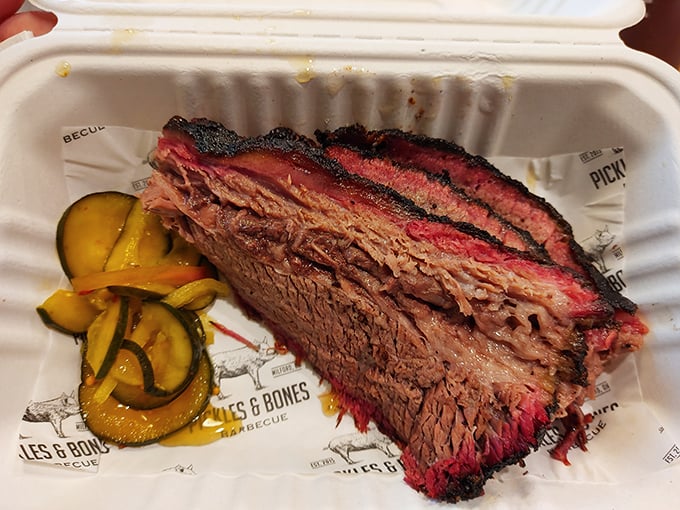 Behold the brisket in all its glory—that smoke ring is like nature's way of applauding the pitmaster. The pickles aren't just garnish; they're essential acid balance.