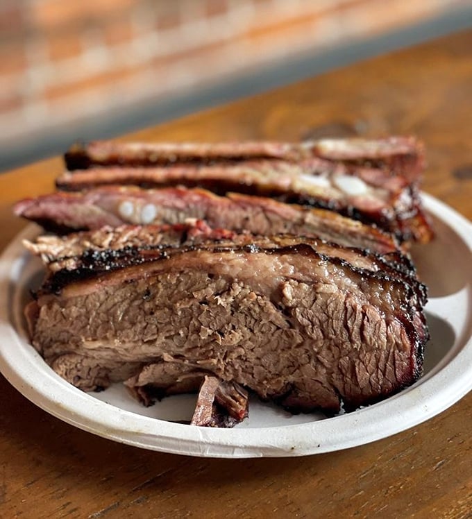 Behold, the brisket of your dreams. That perfect smoke ring and peppery bark aren't just photogenic—they're edible evidence of barbecue mastery.