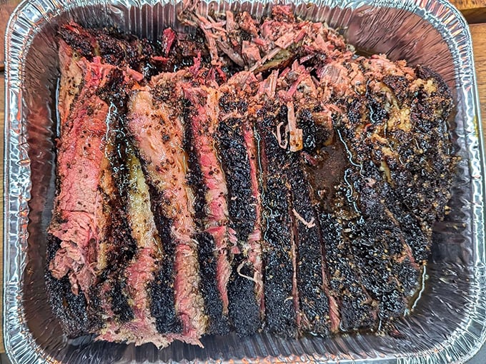 Behold the holy grail of smoked meats: brisket with a bark so perfect it deserves its own exhibition at the Louvre. That smoke ring isn't just pink—it's a halo.