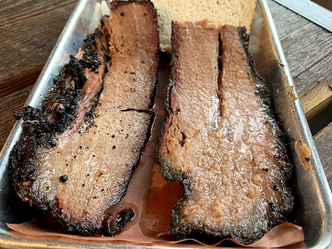 Behold the brisket—bark so perfect it belongs in a museum, with that telltale pink smoke ring that makes barbecue aficionados weak at the knees.