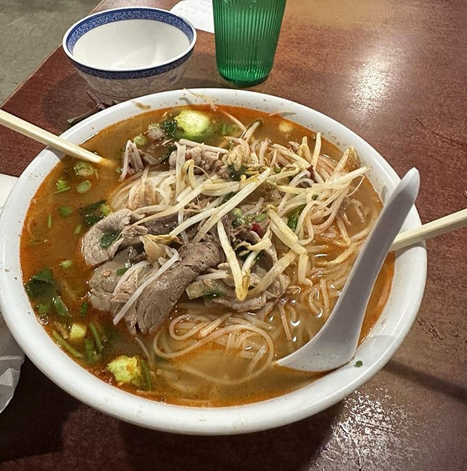 This isn't just soup—it's a steaming bowl of liquid happiness, where tender beef and rice noodles swim in a broth that's been simmering since yesterday.