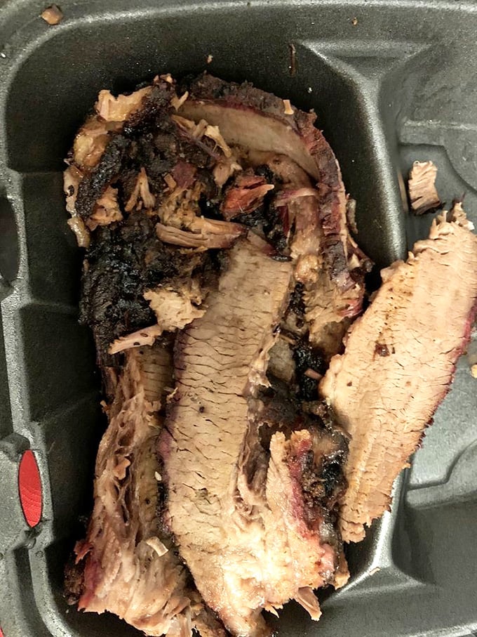 Behold the brisket that launched a thousand food comas – perfectly pink, gorgeously crusted, and absolutely irresistible.