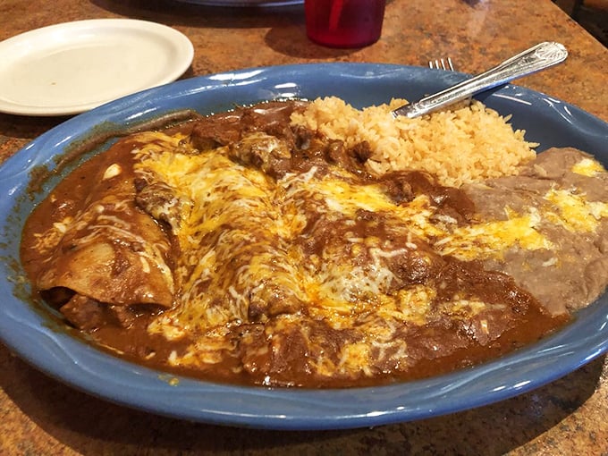 Behold the beef enchiladas—a perfect trinity of tortilla, meat, and sauce swimming in a sea of molten cheese. The holy grail of comfort food.