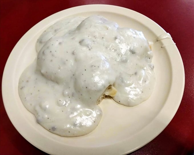Behold the star attraction! These biscuits swimming in creamy, pepper-flecked gravy aren't just breakfast—they're an edible hug that might bring a tear to your eye.
