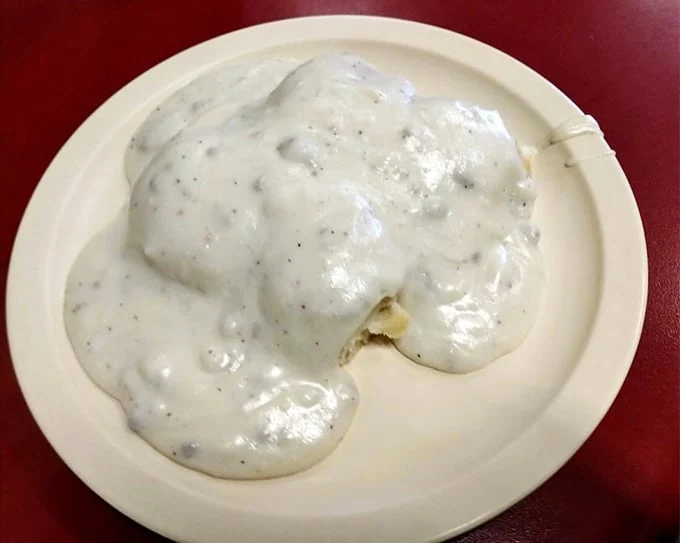 Behold the star attraction! These biscuits swimming in creamy, pepper-flecked gravy aren't just breakfast—they're an edible hug that might bring a tear to your eye.