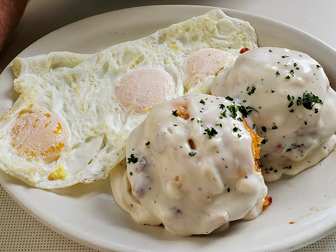 Behold the crown jewel—biscuits smothered in creamy sausage gravy alongside sunny-side-up eggs. Breakfast nirvana that's worth crossing county lines for.