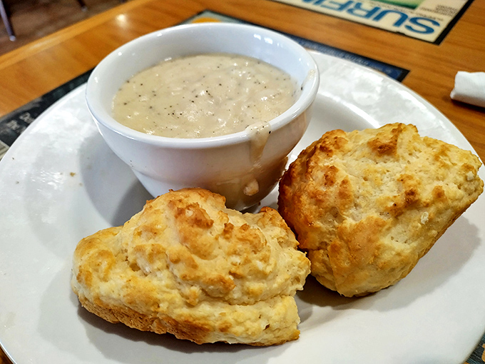 These biscuits and gravy aren't just a meal—they're a spiritual experience. Fluffy clouds of dough swimming in peppery heaven.