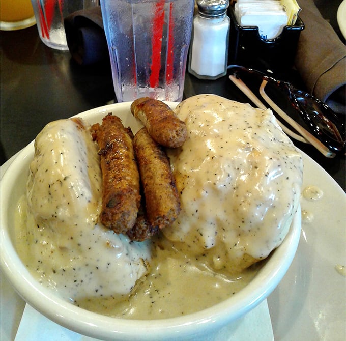 Biscuits drowning in pepper-flecked gravy with sausage links standing guard – this plate doesn't just feed you, it hugs your soul.
