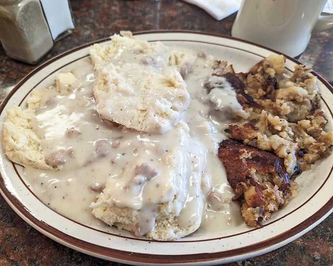 Behold the holy grail—biscuits and gravy that would make your grandmother both proud and jealous, with hash browns crisped to golden perfection.