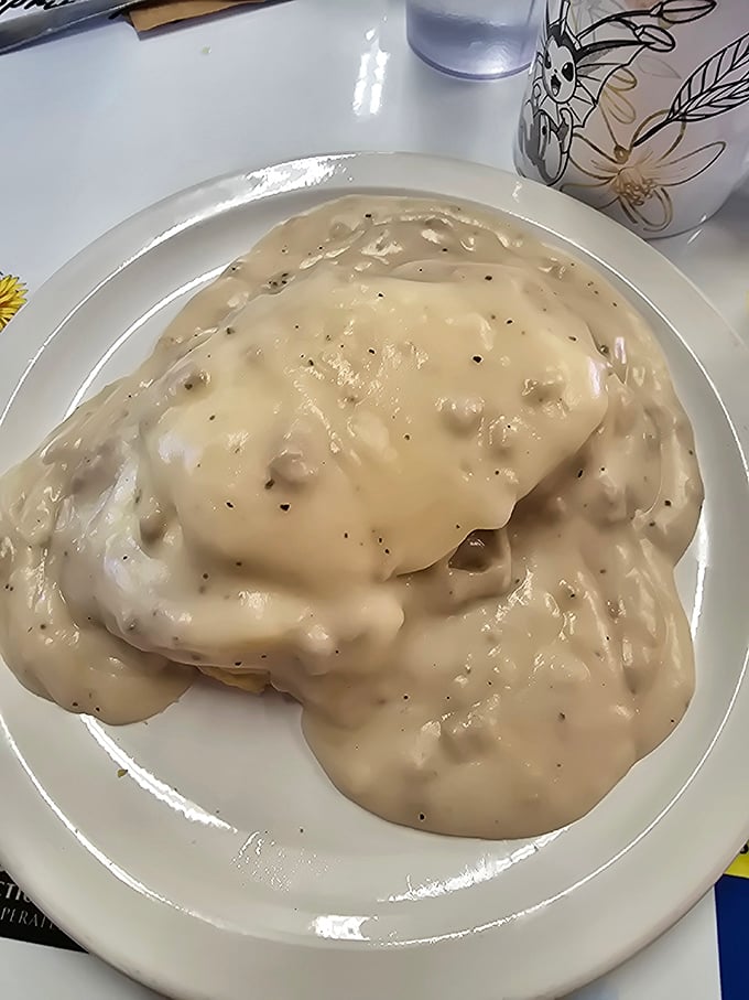 Behold the holy grail of comfort food: biscuits drowning in peppery sausage gravy. Your diet plan just called—it's taking the day off.