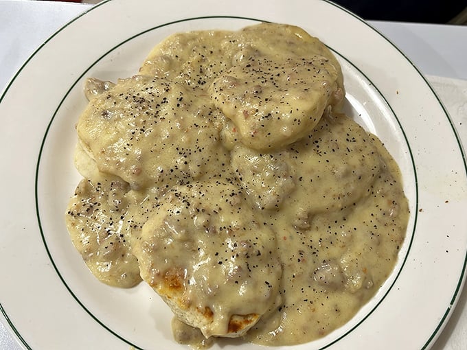 Behold the holy grail of comfort food! These biscuits swimming in peppery sausage gravy aren't just breakfast—they're an edible hug on a plate.