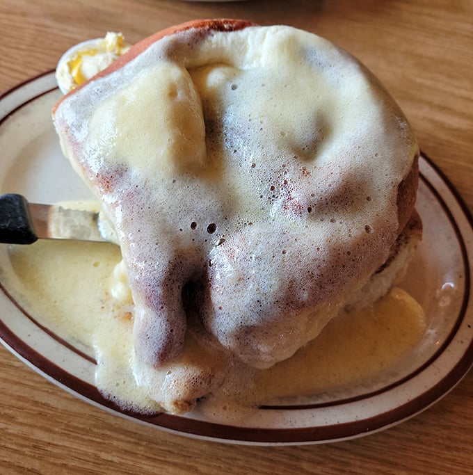 This isn't just biscuits and gravy—it's a gravity-defying cloud of carbs swimming in a sea of peppery salvation that would make your grandmother weep with joy.