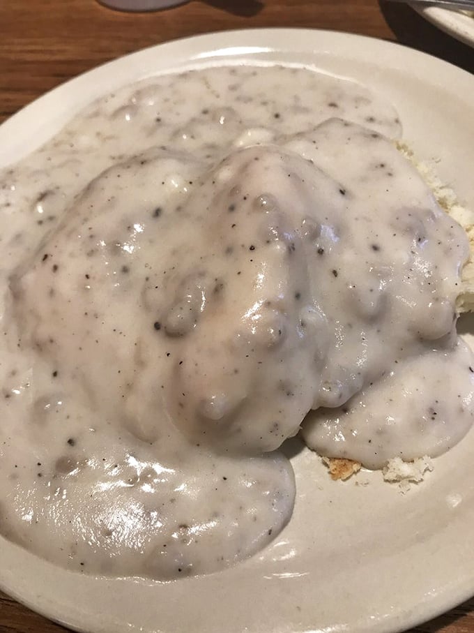 Behold the holy grail of breakfast: biscuits drowning happily in peppery gravy. Not all heroes wear capes; some wear flour.