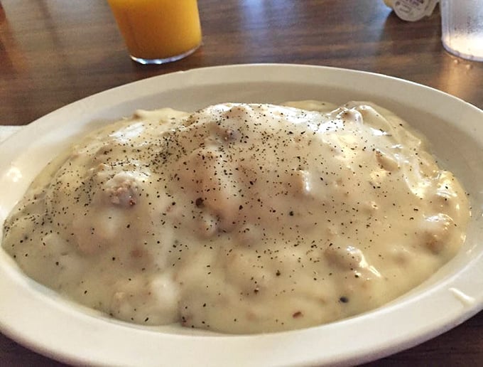 Behold the holy grail of comfort food—country gravy speckled with sausage, ready to blanket those biscuits in a peppery hug that warms the soul.