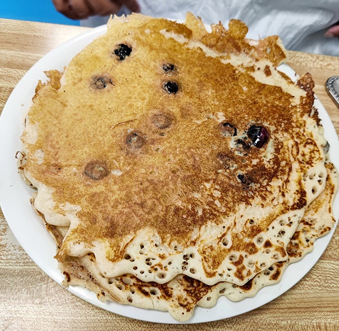 These blueberry pancakes aren't just breakfast—they're edible art with crispy edges and pockets of warm berries that burst like tiny flavor bombs.