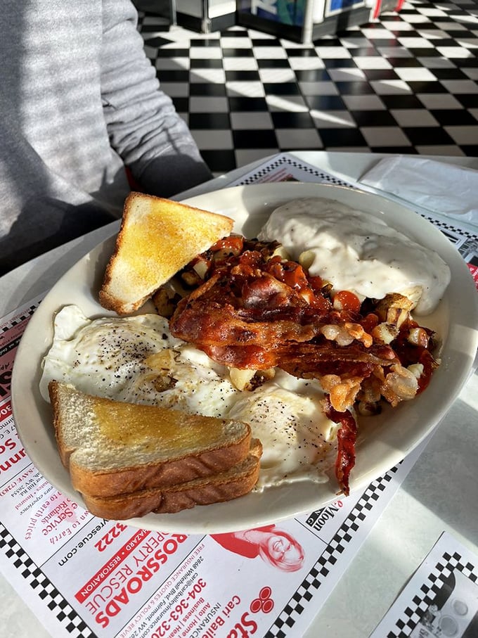 Breakfast nirvana achieved: eggs, bacon, home fries, and toast with a side of nostalgia. This plate doesn't just feed your body – it hugs your soul.