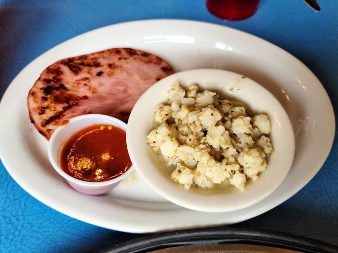 A slice of ham alongside perfectly seasoned potatoes. Simple food done right is one of life's most underrated pleasures.