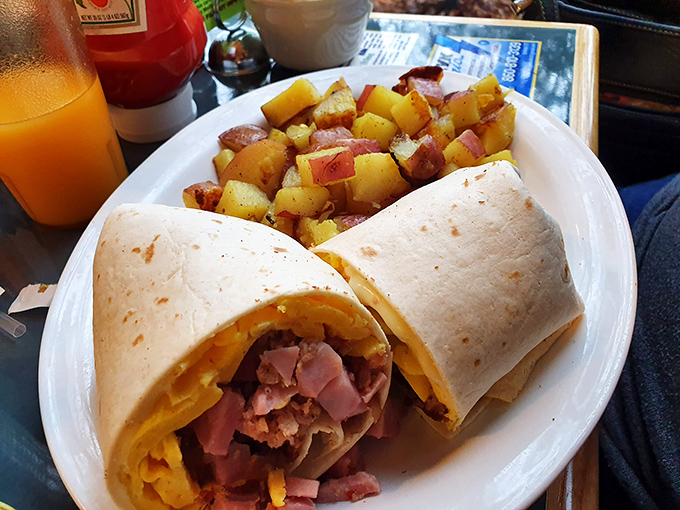 The legendary breakfast burrito in all its glory—a perfect marriage of fluffy eggs, savory ham, and melted cheese wrapped in a griddled tortilla. Breakfast nirvana achieved!