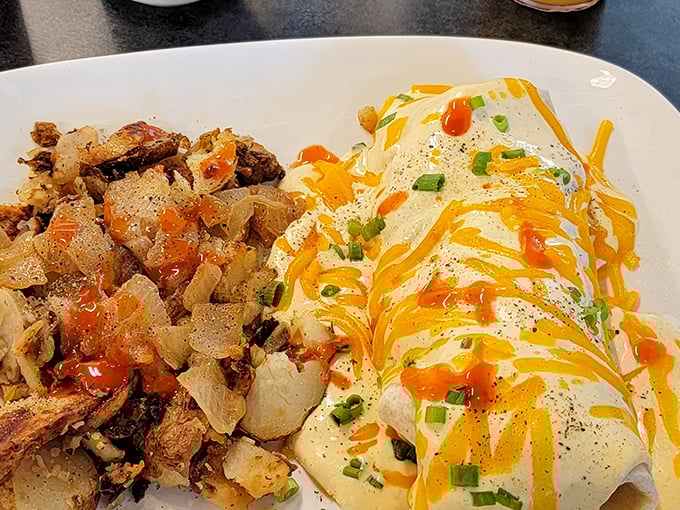 Behold the breakfast burrito's sophisticated cousin—draped in melted cheese and adorned with green onions, it's the morning equivalent of wearing a tuxedo to bed.