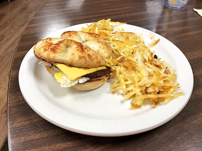 Behold the breakfast sandwich in its natural habitat—perfectly toasted English muffin, melty cheese, and that golden hash brown side that's crispy in all the right places.