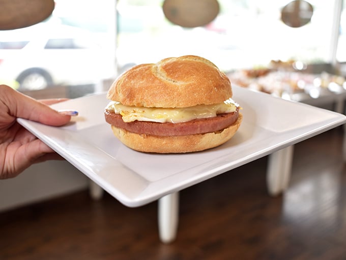 Behold the humble hero of Bread Pete—a perfectly executed breakfast sandwich where the Kaiser roll is the unsung star of this morning masterpiece.