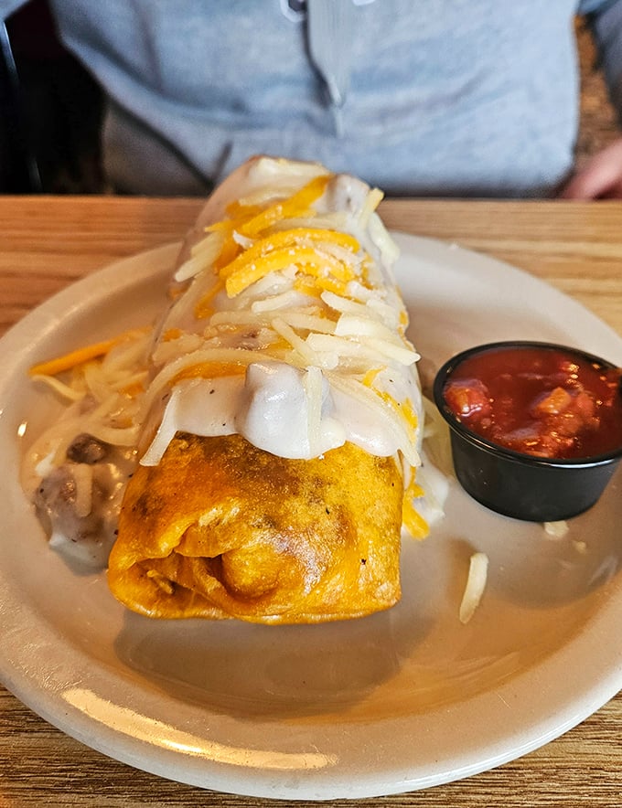 Behold the breakfast burrito in all its cheese-crowned glory! That side of salsa isn't just a condiment—it's a flavor wingman waiting to elevate each bite.